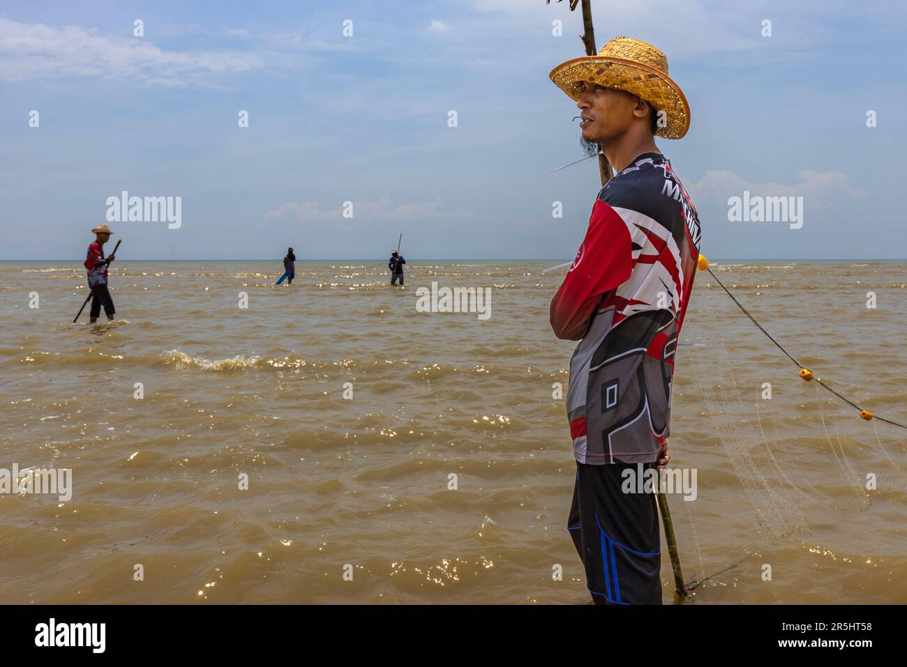 Fishing at beach Stock Photo - Alamy