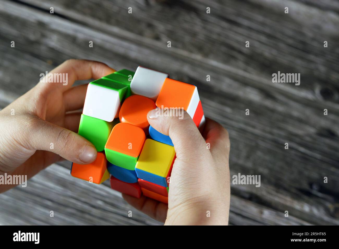 Cairo, Egypt, May 26 2023: Solving the Rubik's Cube by a child, combination puzzle, speed magic ...