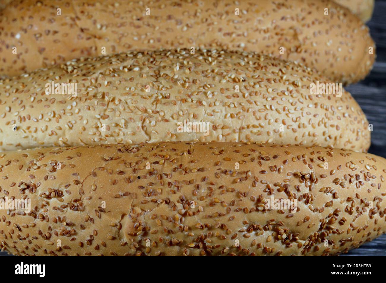 Long sesame bun bread, a fresh baked loaf of bread French Fino ready to ...