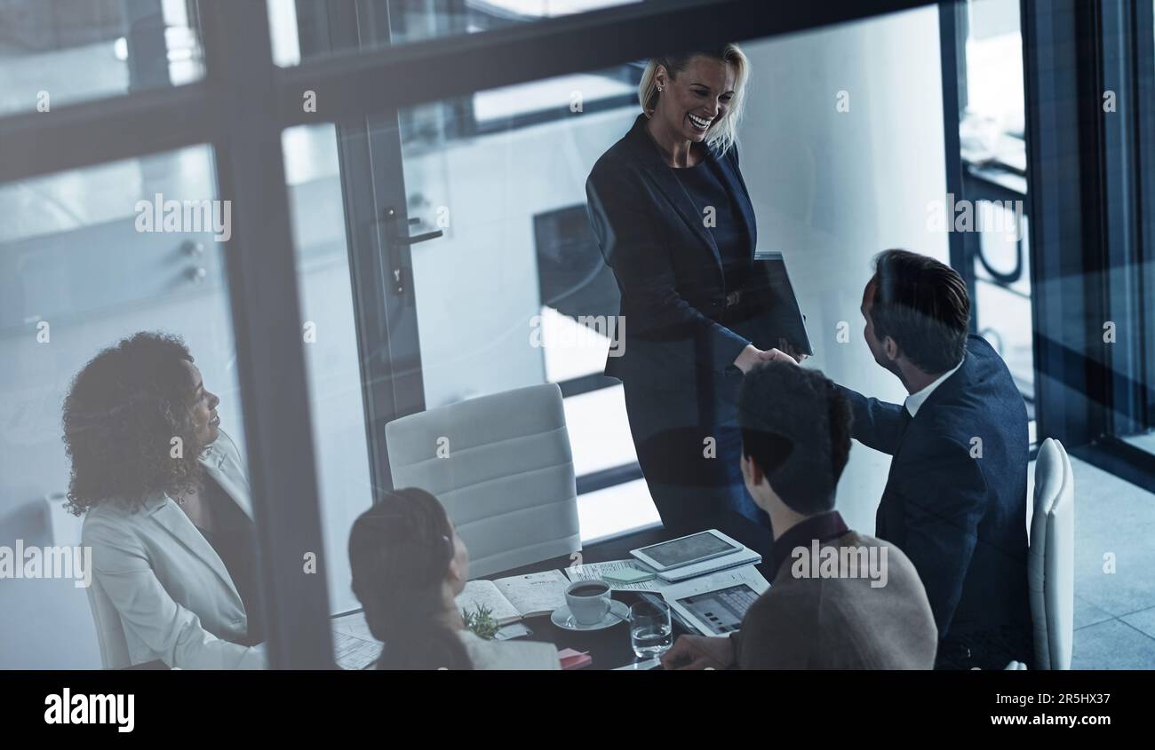 Were happy to have you on board. two corporate colleagues shaking hands ...