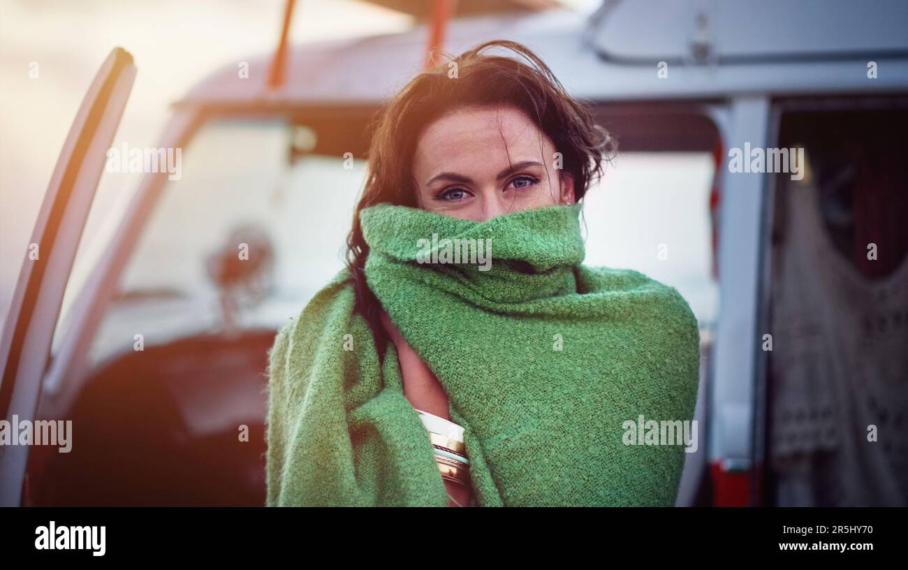 Snug as a bug in a rug. Portrait of an attractive young woman wrapped ...