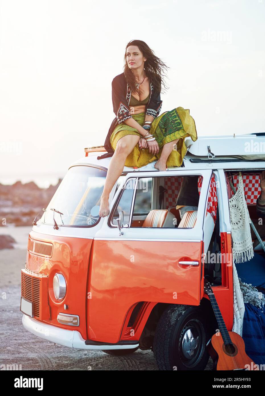 Getting some of that fresh sea air. a young woman stopping at the beach ...