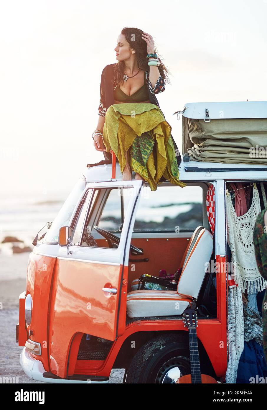Taking a break on the beach. a young woman stopping at the beach during ...
