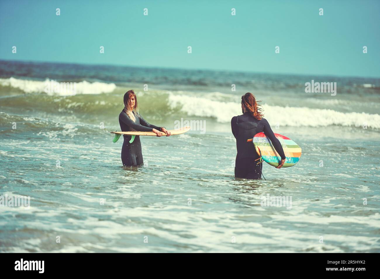 Theyre a match made in surfing heaven. a young couple surfing at the ...