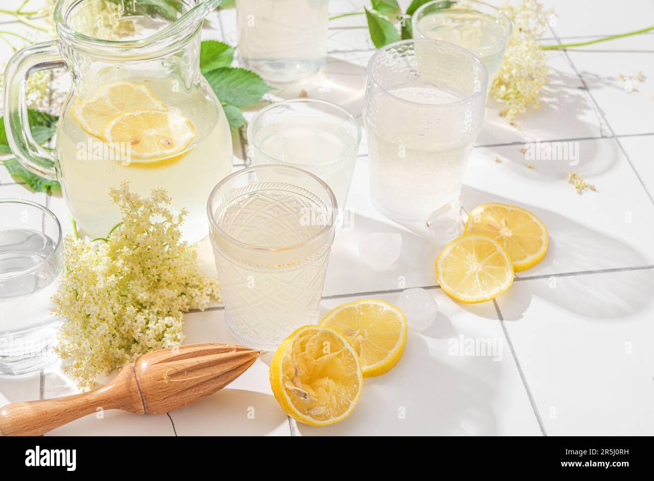 Fresh iced lemonade with lemons and elderberry flowers in a jar and ...