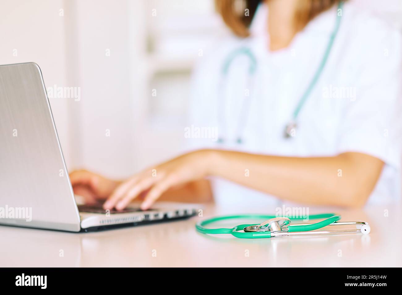 Medical background, stethoscope and doctor using computer on background ...