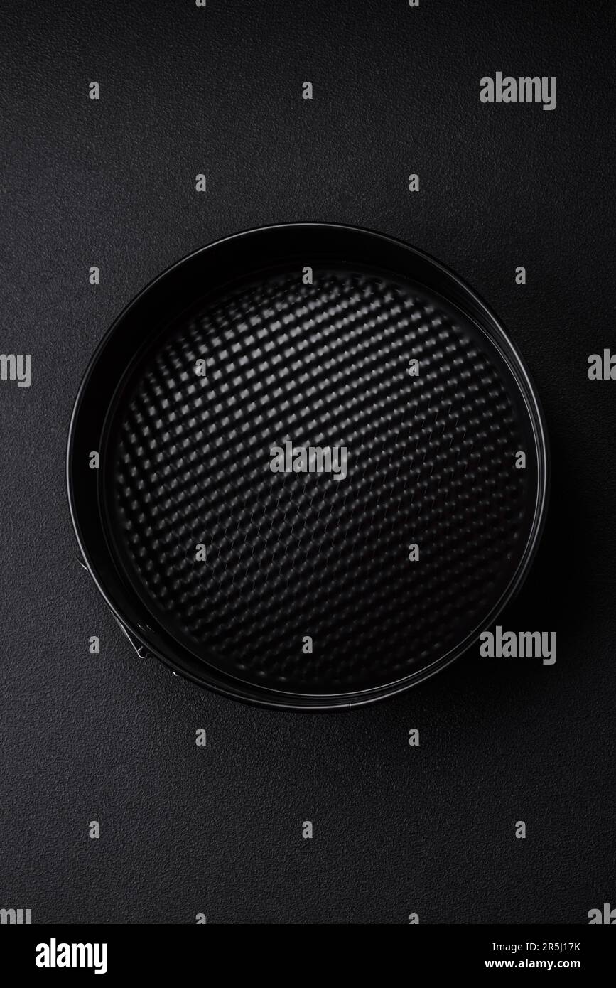 Round metal black detachable baking dish for baking on a dark concrete ...