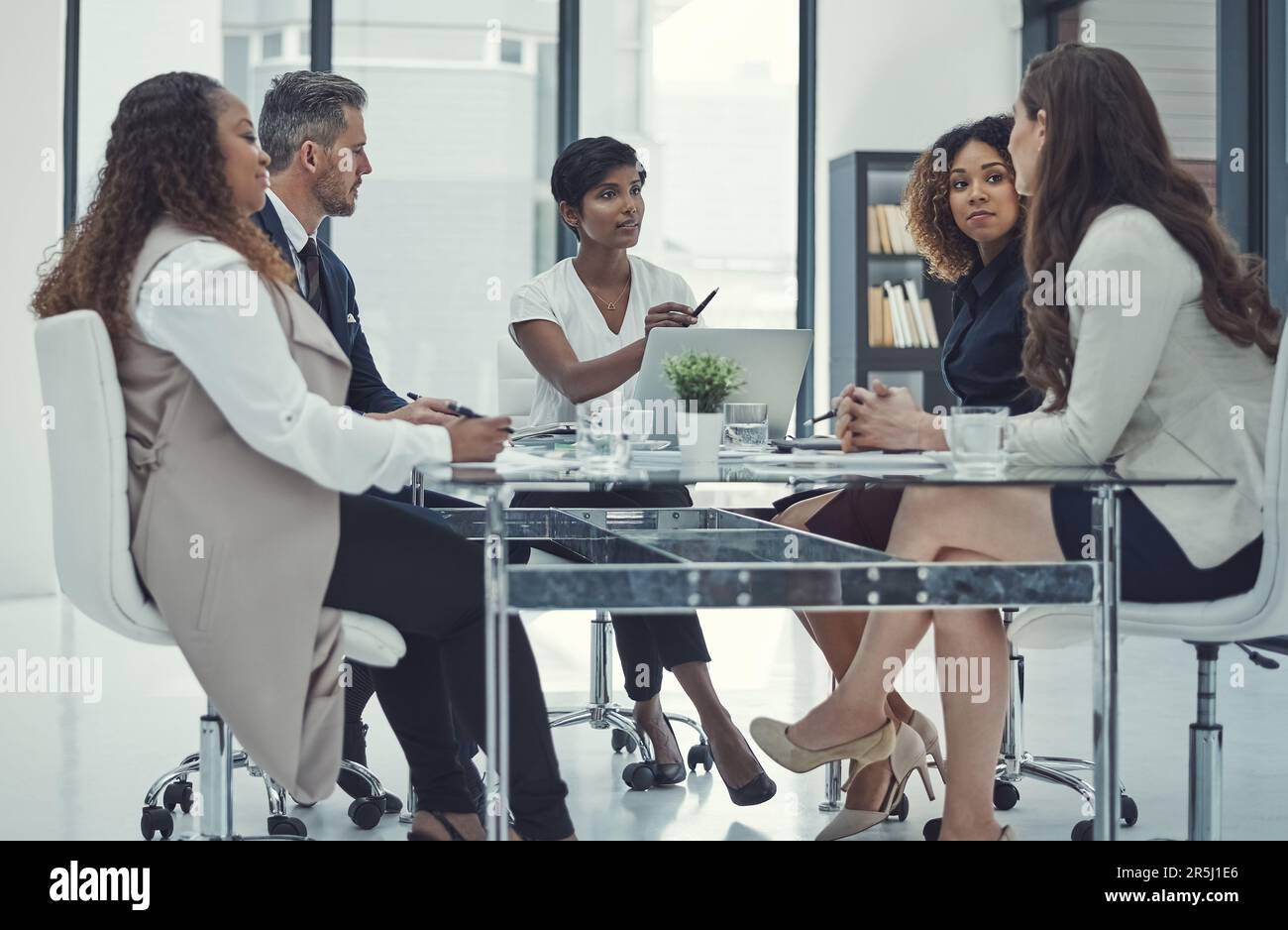 Outlining a solid strategy. a group of colleagues having a meeting in a ...