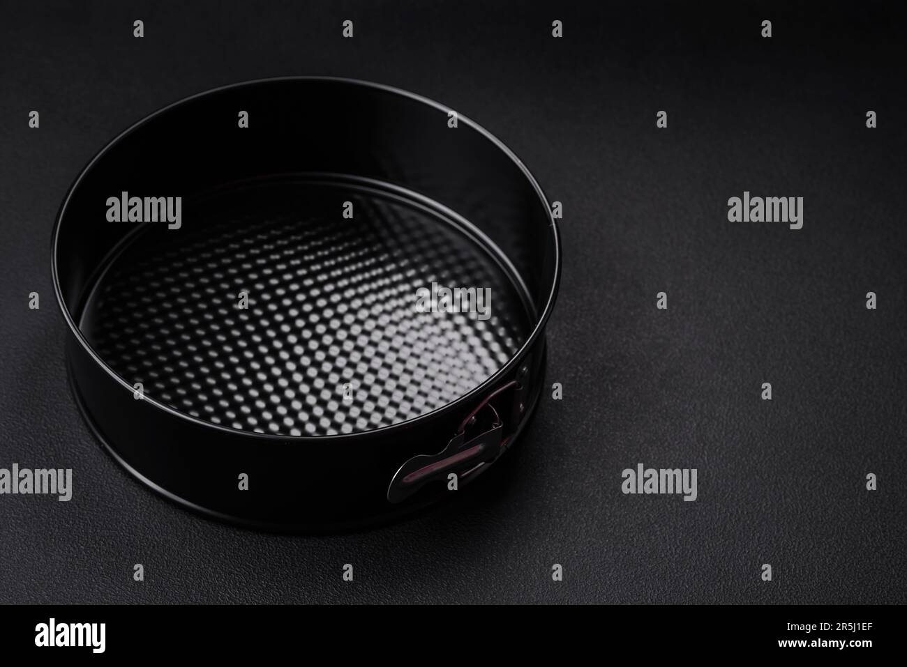 Round metal black detachable baking dish for baking on a dark concrete ...