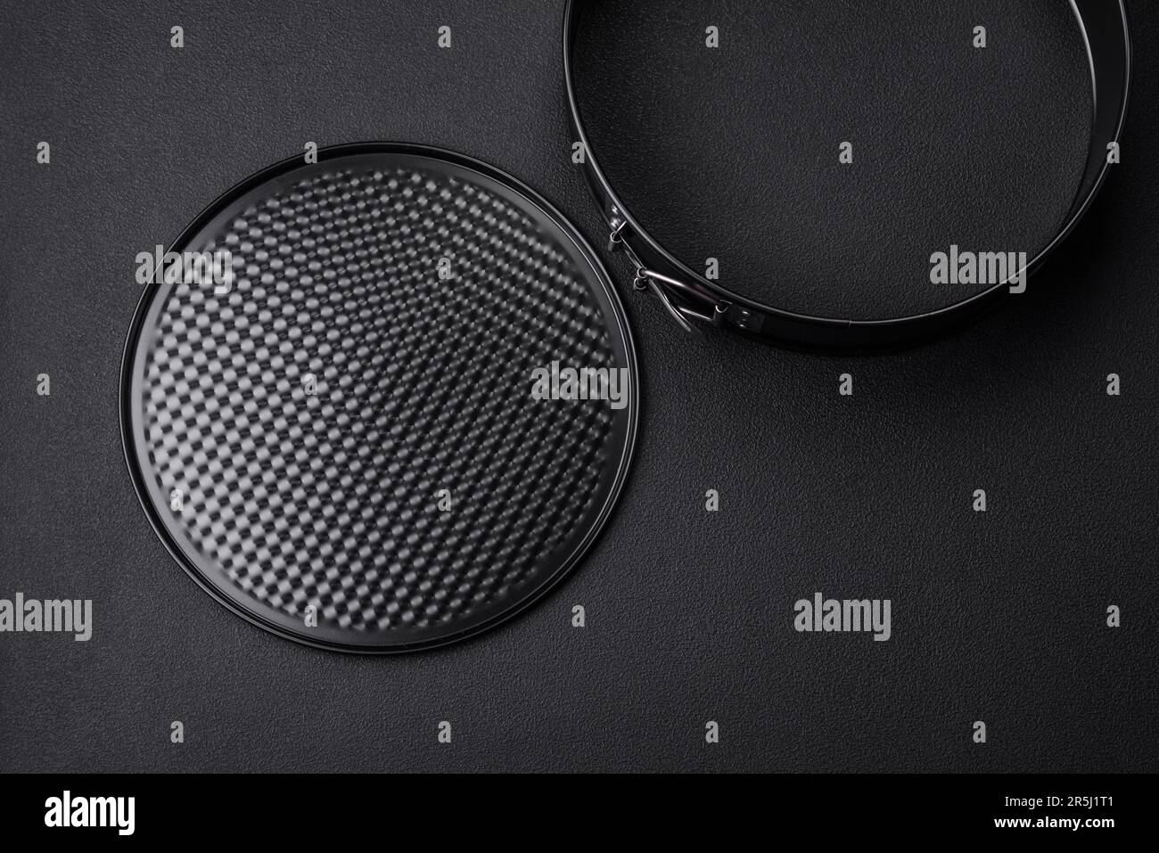 Round metal black detachable baking dish for baking on a dark concrete ...