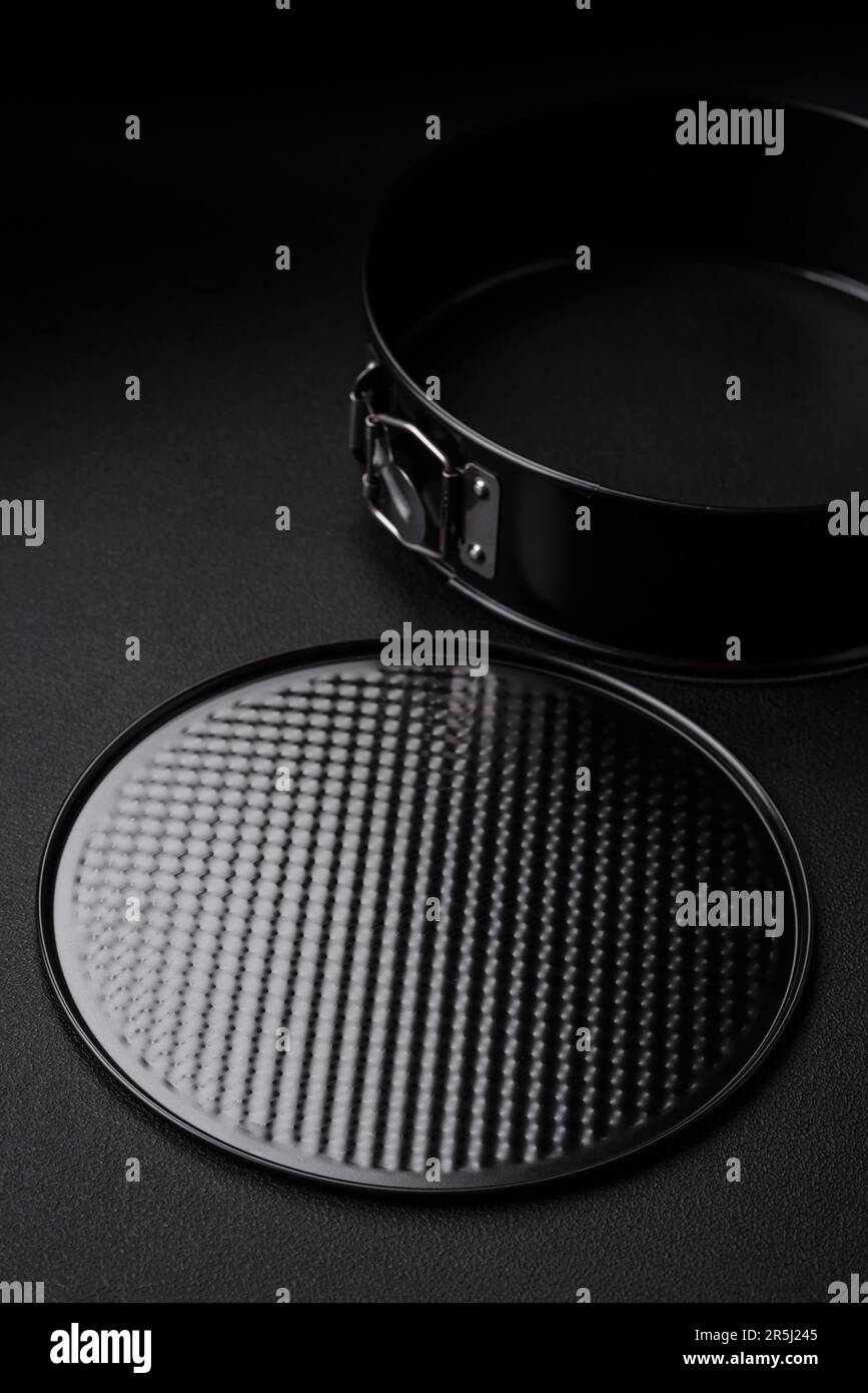 Round metal black detachable baking dish for baking on a dark concrete ...