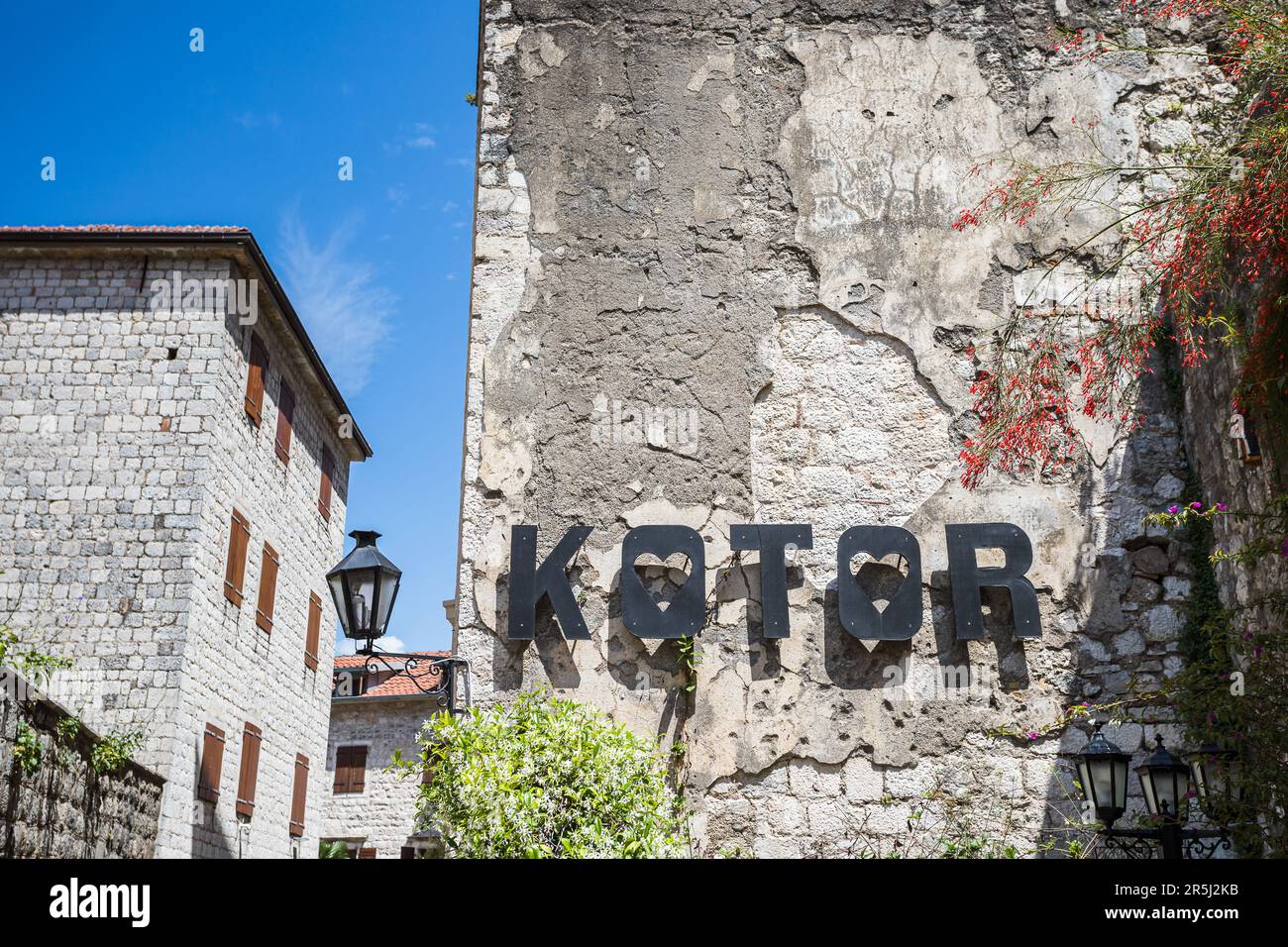 Large letters seen on the side of a building in Kotor spell out the ...