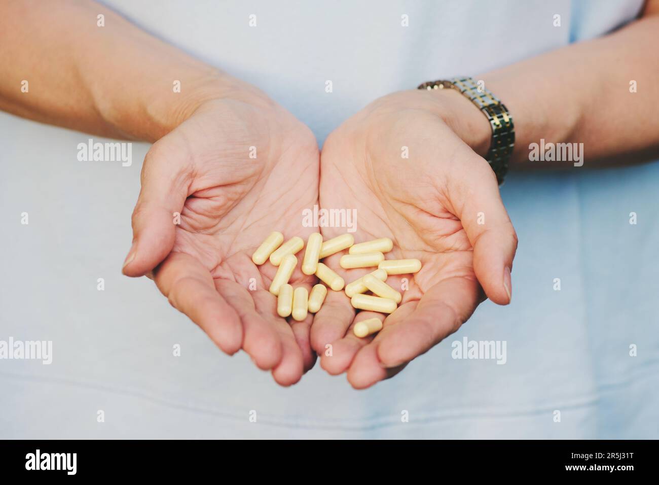 Close up image of female hands holding bunch of capsules, medical ...