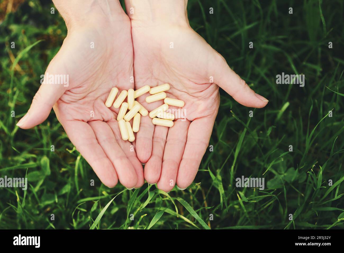 Close up image of female hands holding bunch of capsules, medical ...