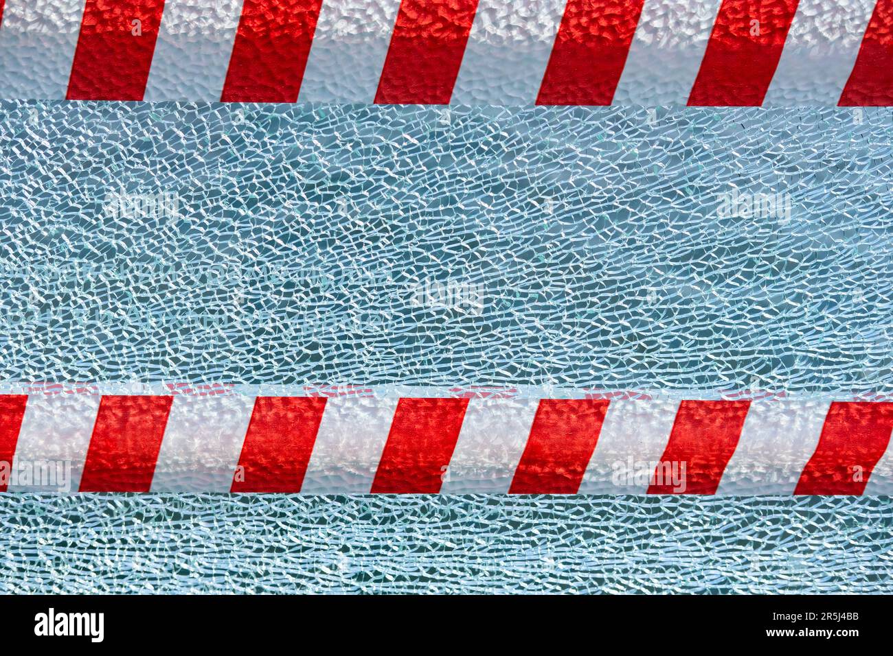broken glass background with red and white ribbon. Danger sign and stop ...