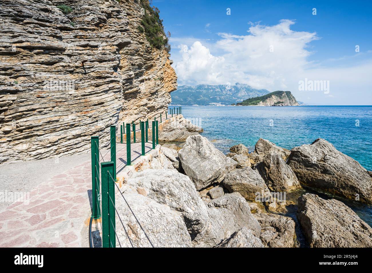 The railing line pathway winding under the cliffs from Mogren Beach to ...
