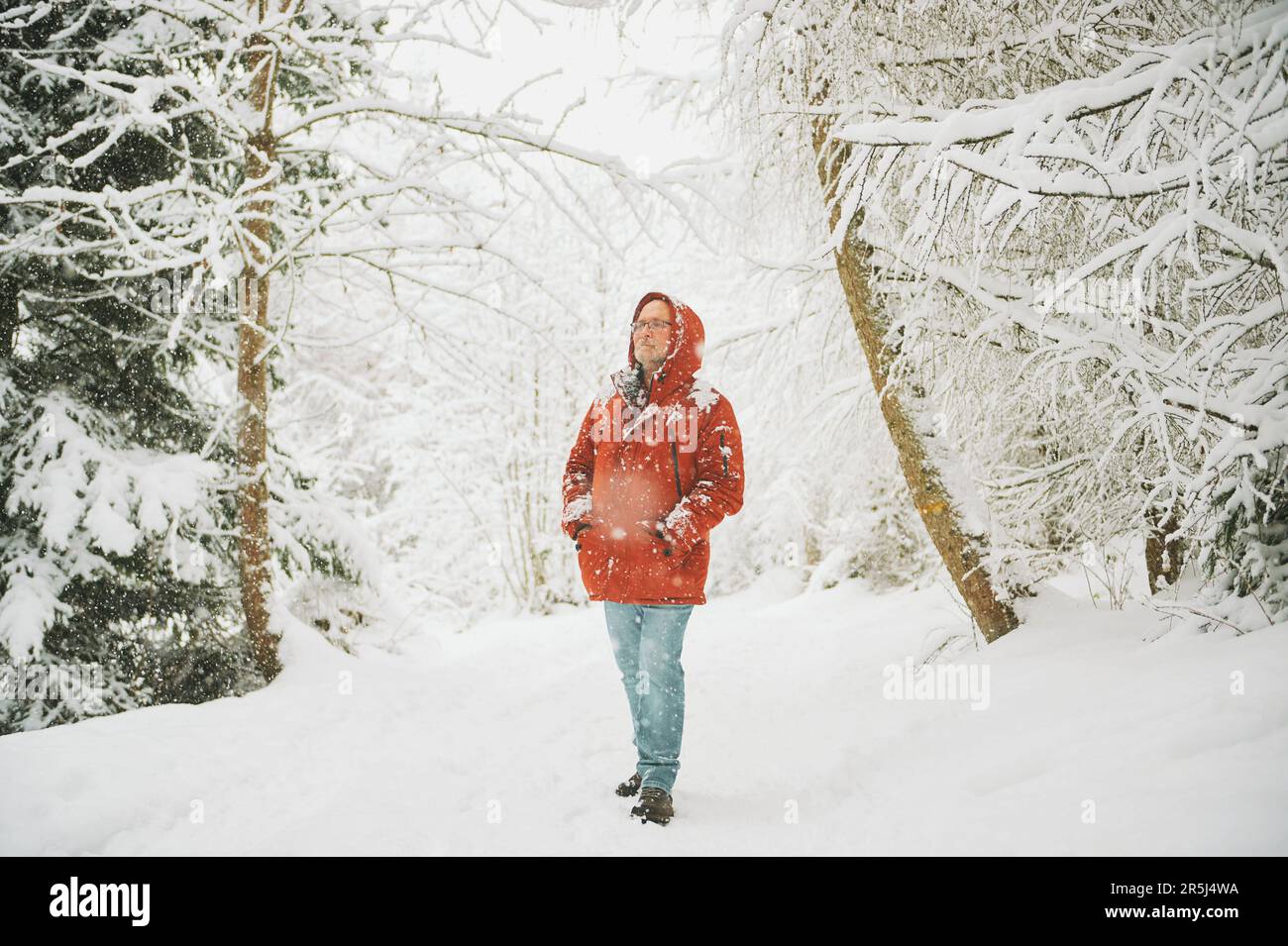 Outdoor portrait of middle age man enjoying nice day in winter forest ...