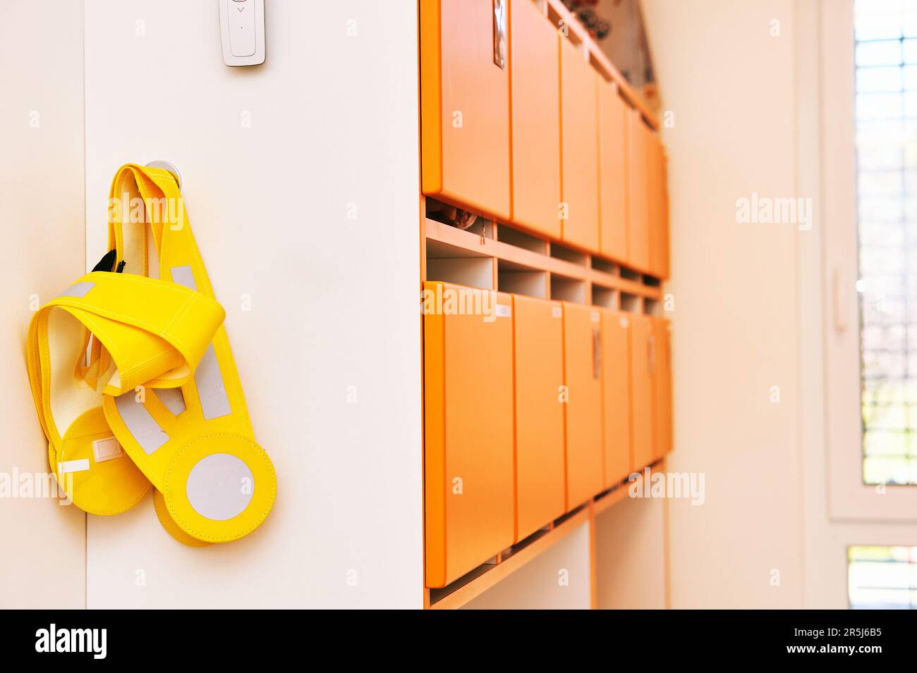 Empty hallway with small lockers in day care or kindergarten, many ...