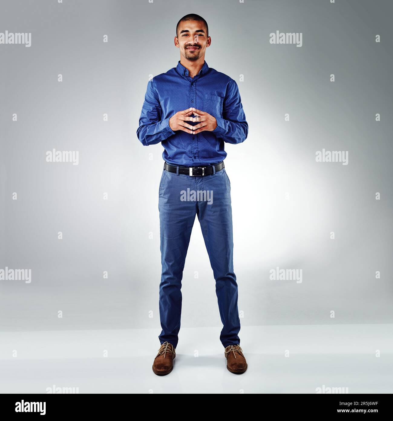 I get closer and closer each day...a young businessman posing against a ...