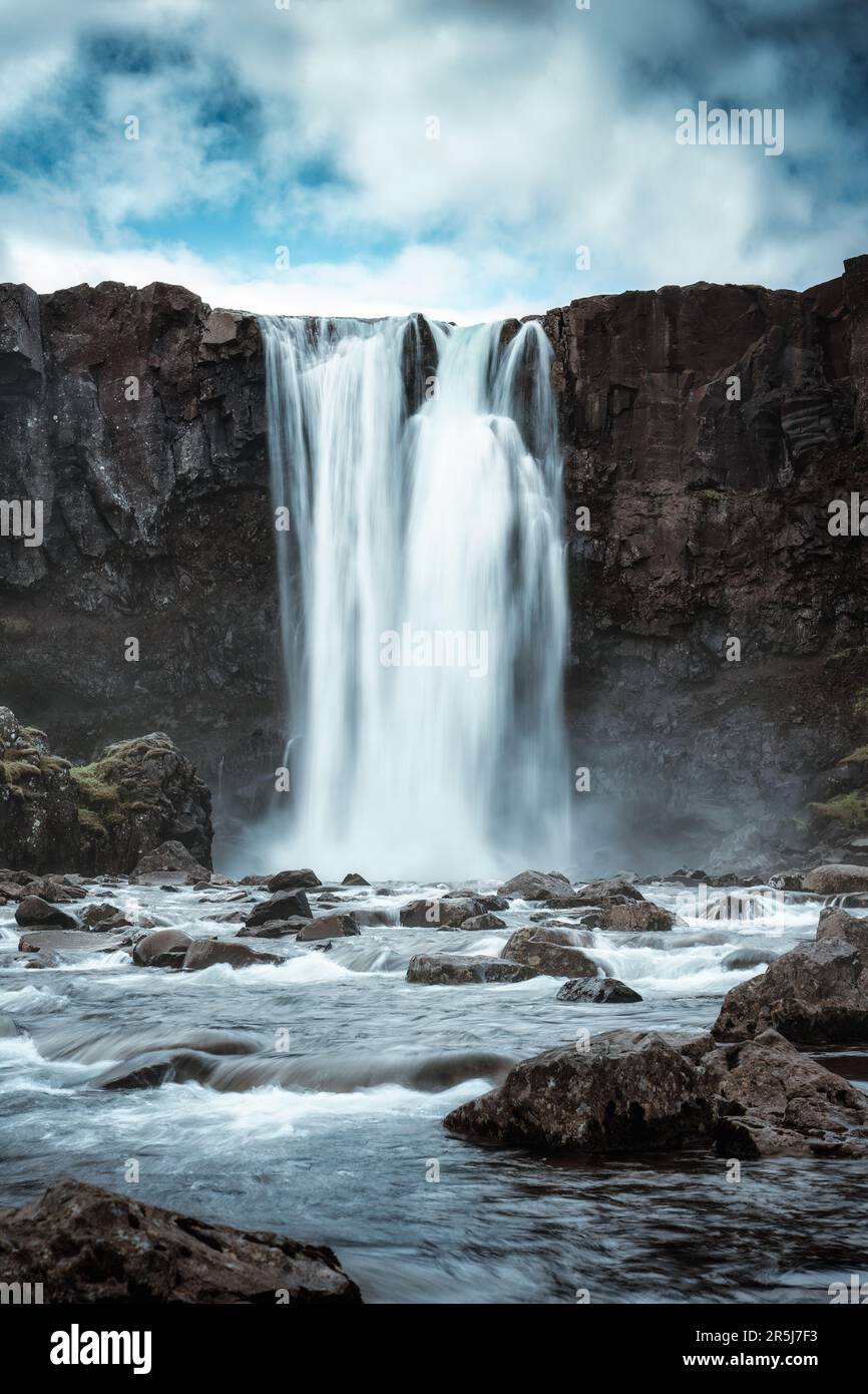 Dramatic scenery of Gufufoss waterfall flowing on summer in east fjords ...