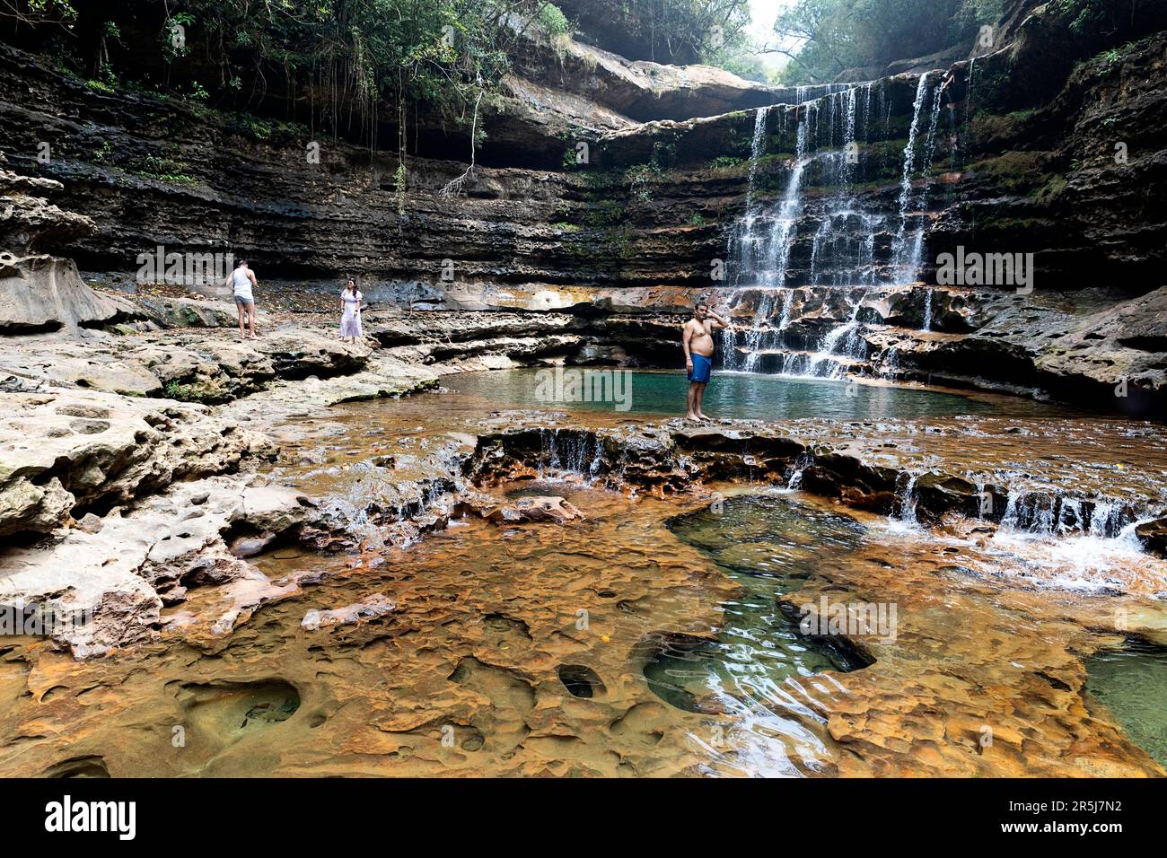 Tourists enjoying next to the pools of beautiful Wei Sawdong waterfalls ... Tourists enjoying next to the pools of beautiful Wei Sawdong waterfalls ...