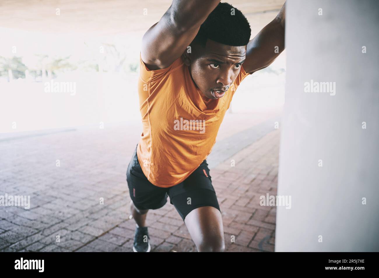 When you feel the burn, you know youve earned. a young man stretching ...