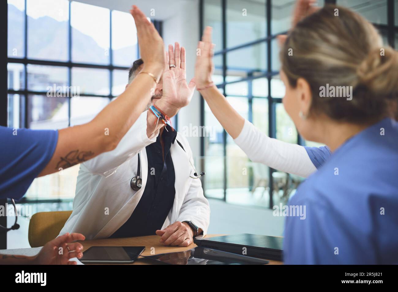 High fiving to good health. a team of doctors giving each other a high ...
