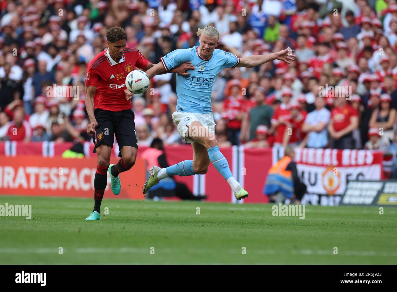 Manchester City's Erling Haaland holds of Manchester United's Raphael ...