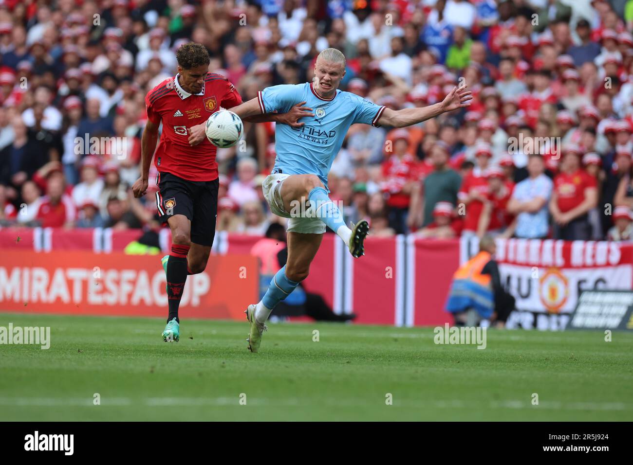 Manchester City's Erling Haaland holds of Manchester United's Raphael ...
