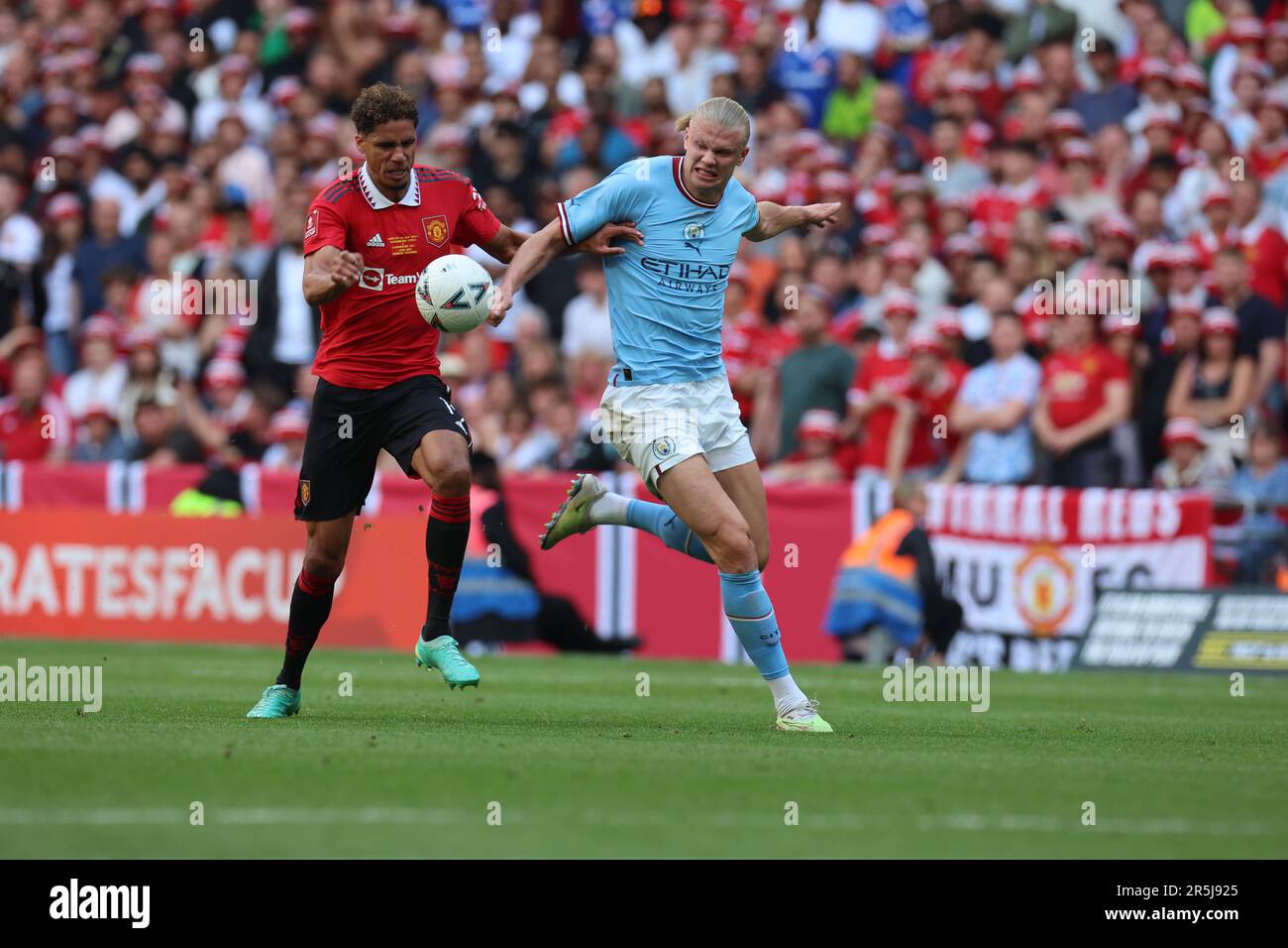 Manchester City's Erling Haaland holds of Manchester United's Raphael ...