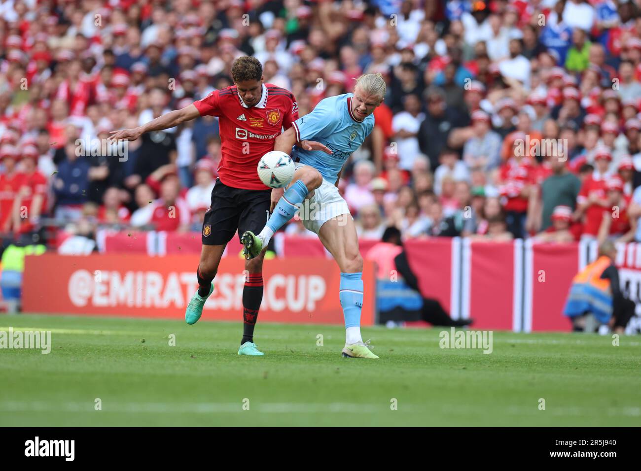 Manchester City's Erling Haaland holds of Manchester United's Raphael ...