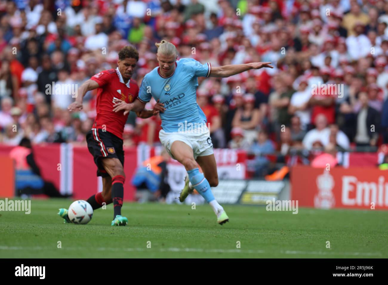 Manchester City's Erling Haaland holds of Manchester United's Raphael ...