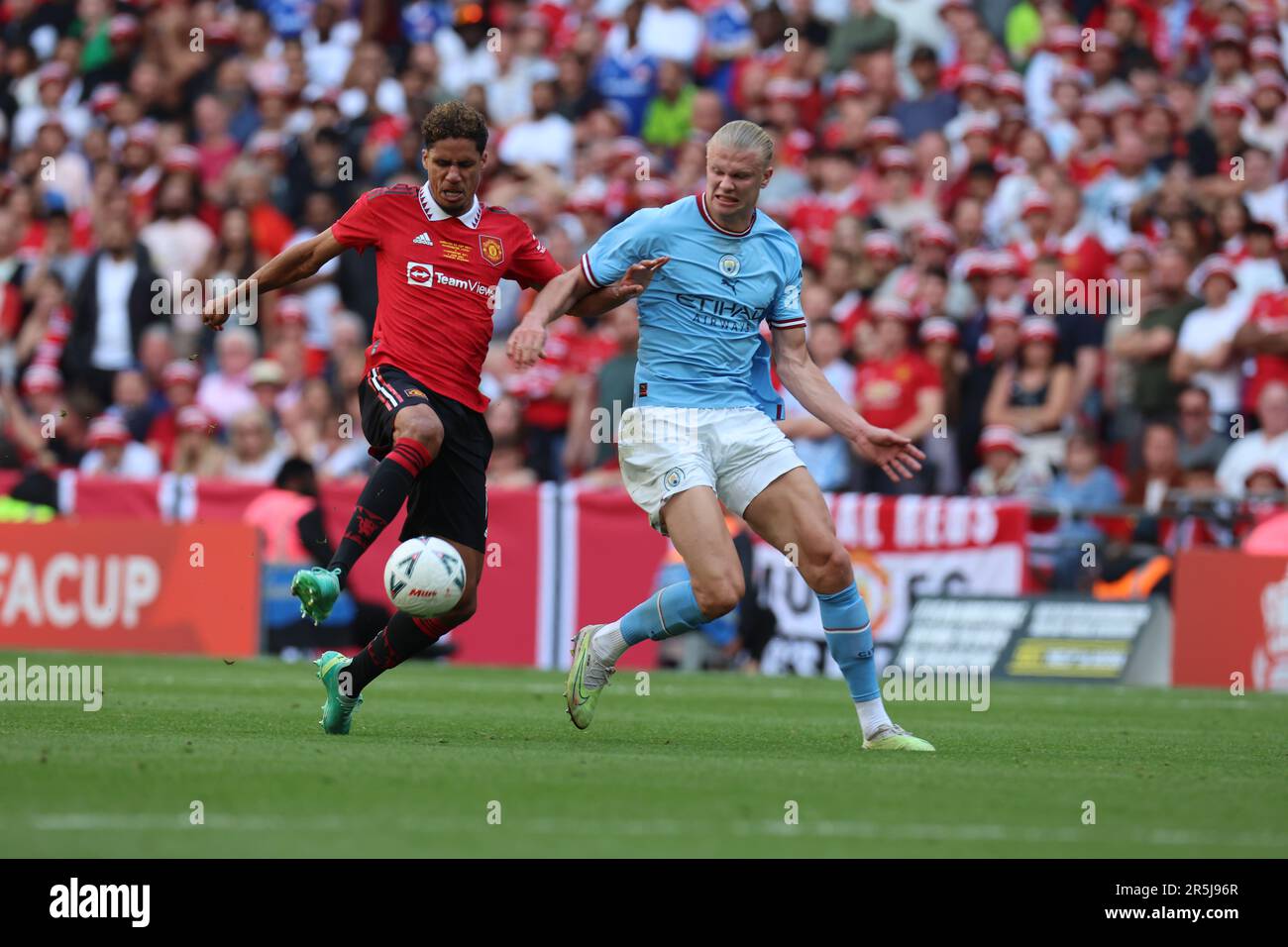 Manchester City's Erling Haaland holds of Manchester United's Raphael ...