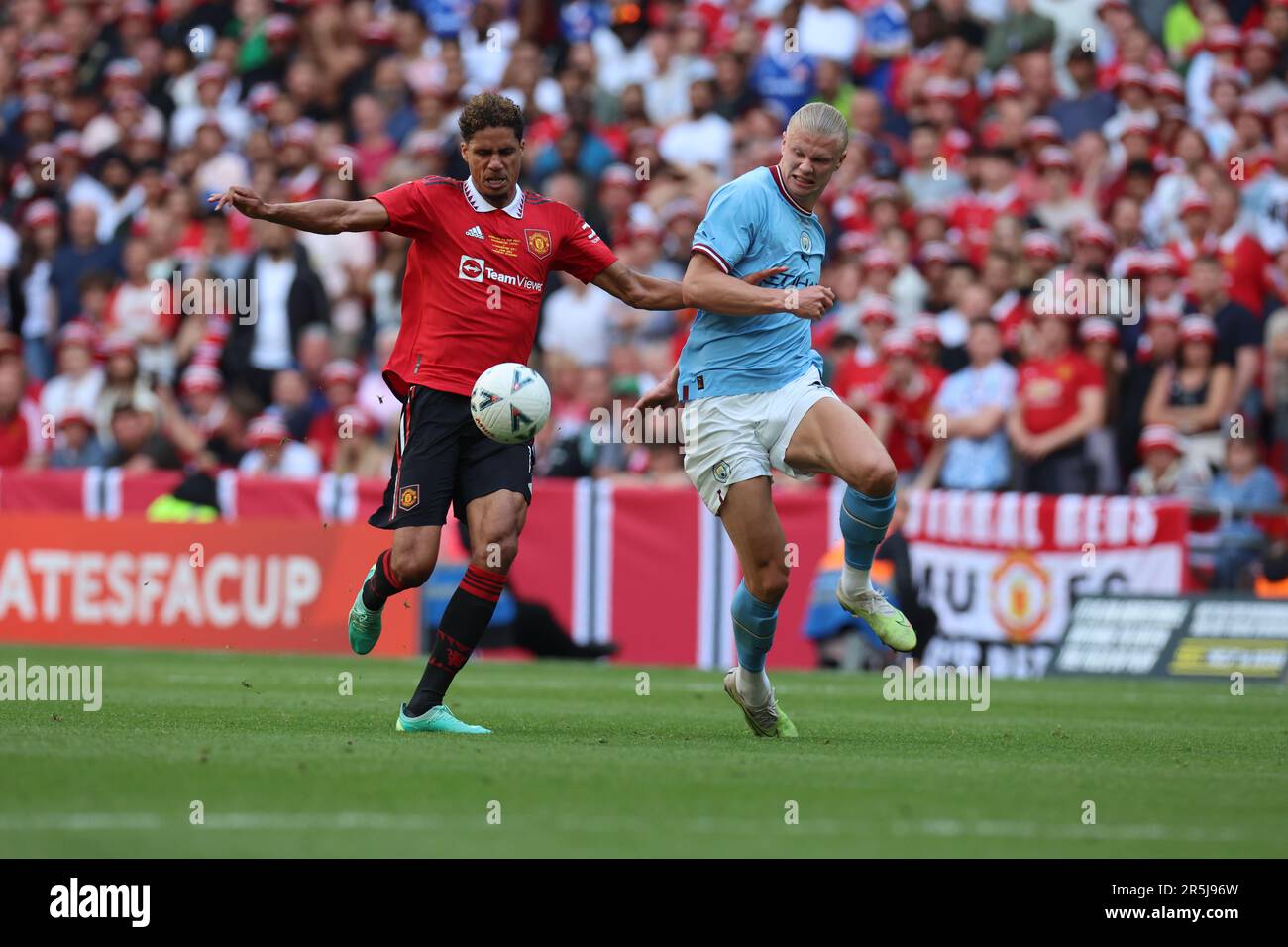 Manchester City's Erling Haaland holds of Manchester United's Raphael ...