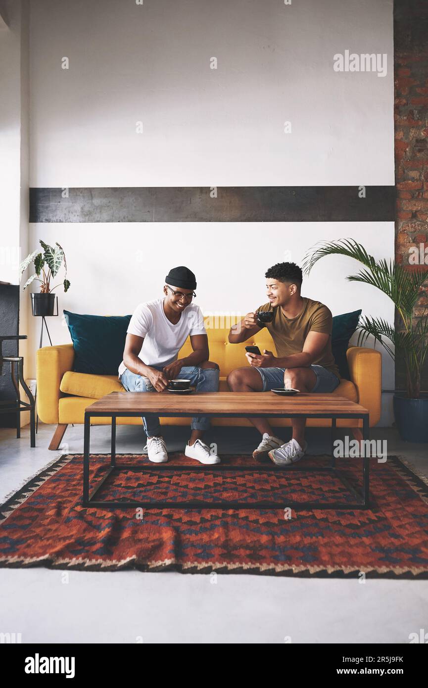 The coffee really is as good as they say here. two young men sitting ...