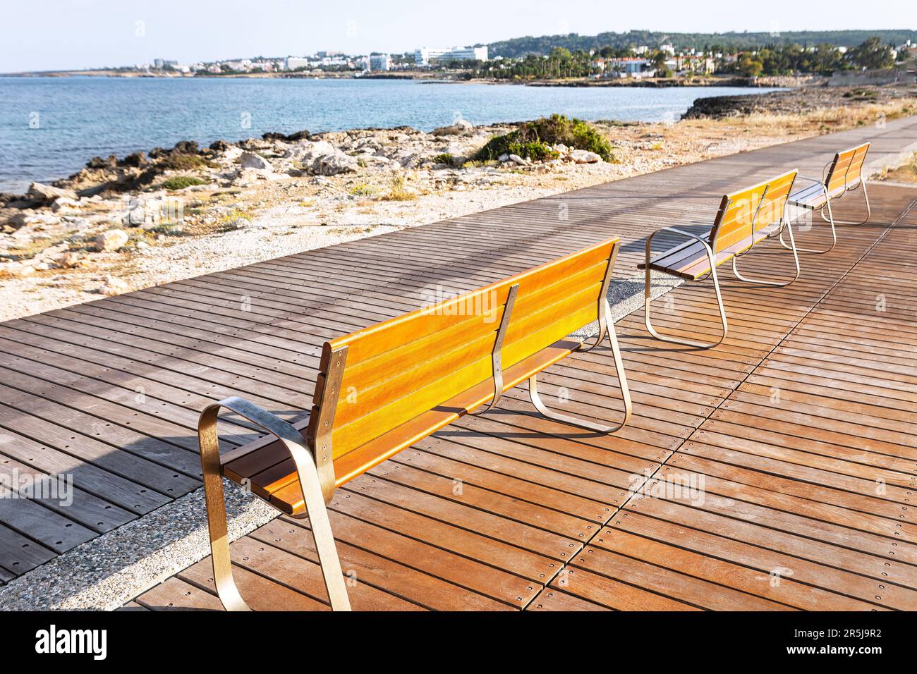 Empty benches at seaside . Wooden seats on the sea coast Stock Photo ...