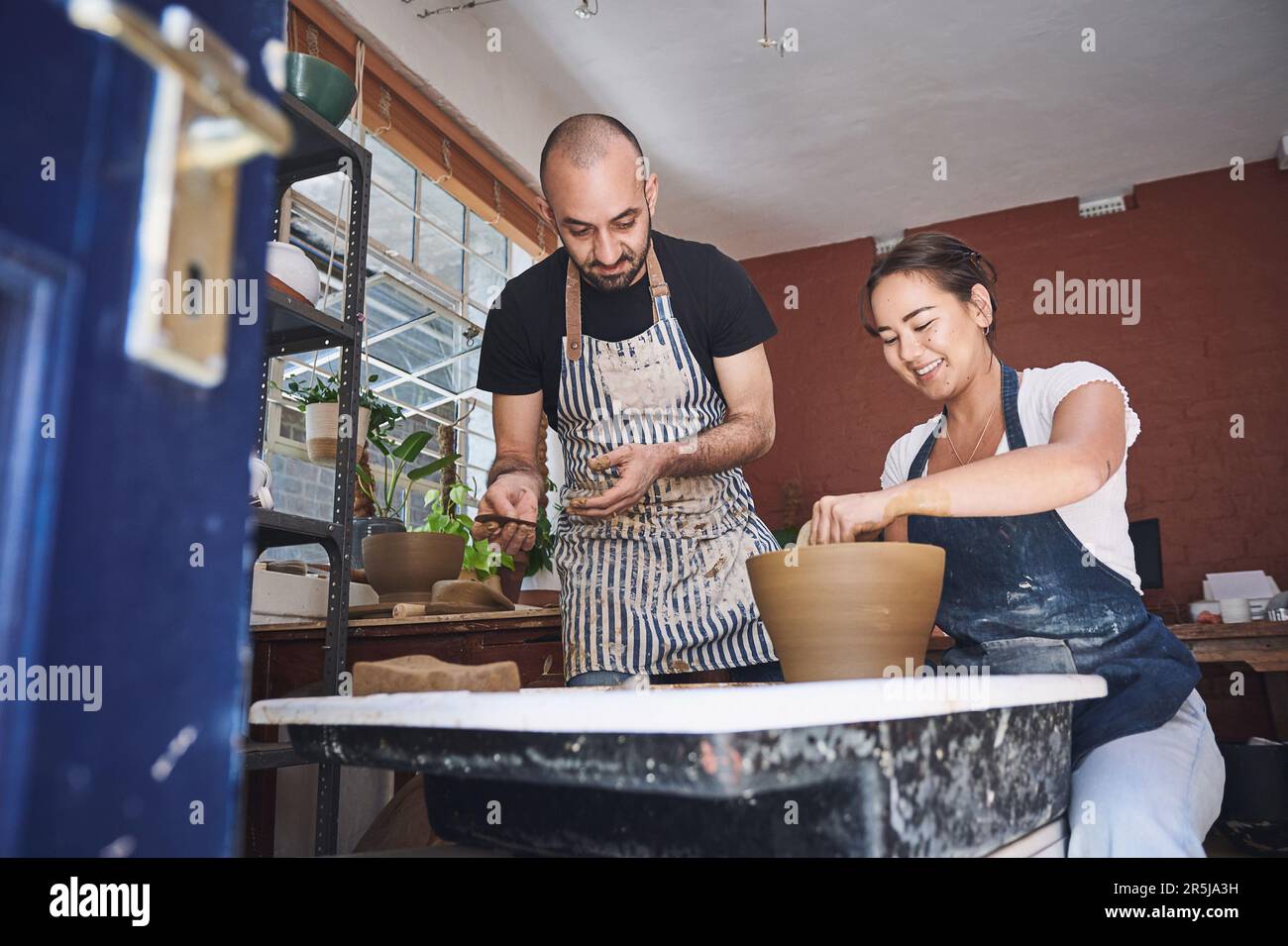 Where theres art, theres heart. a young man and woman working with clay ...