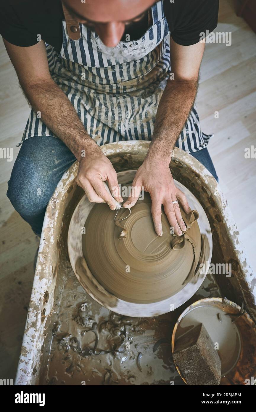 Youve gotta hand it to his pottery technique. a man working with clay ...