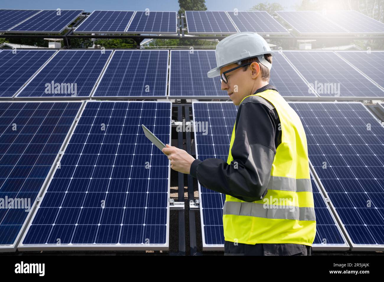 Engineer with tablet computer on a background of mobile solar energy ...