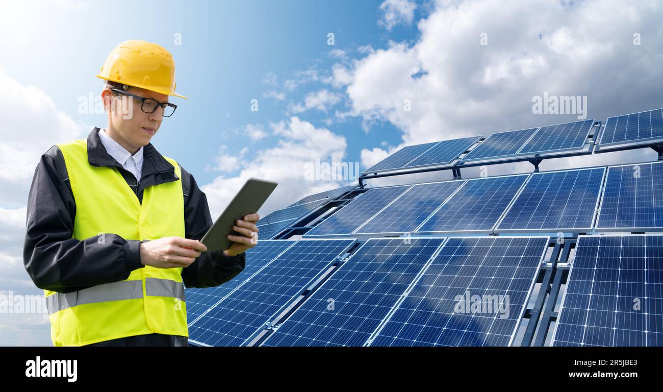Engineer with tablet computer on a background of mobile solar energy ...