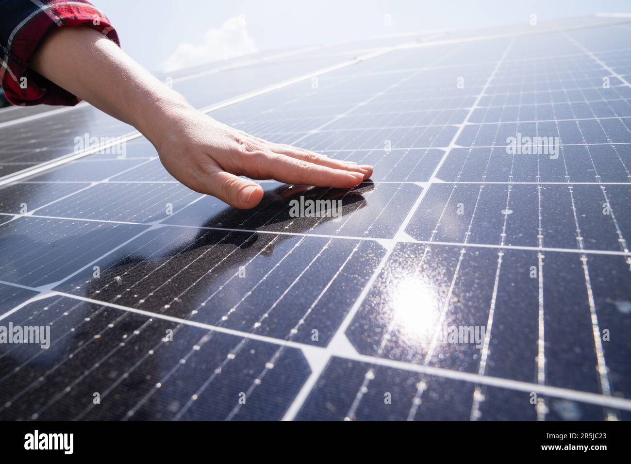 Close-up of a hand touching a solar panel Stock Photo - Alamy