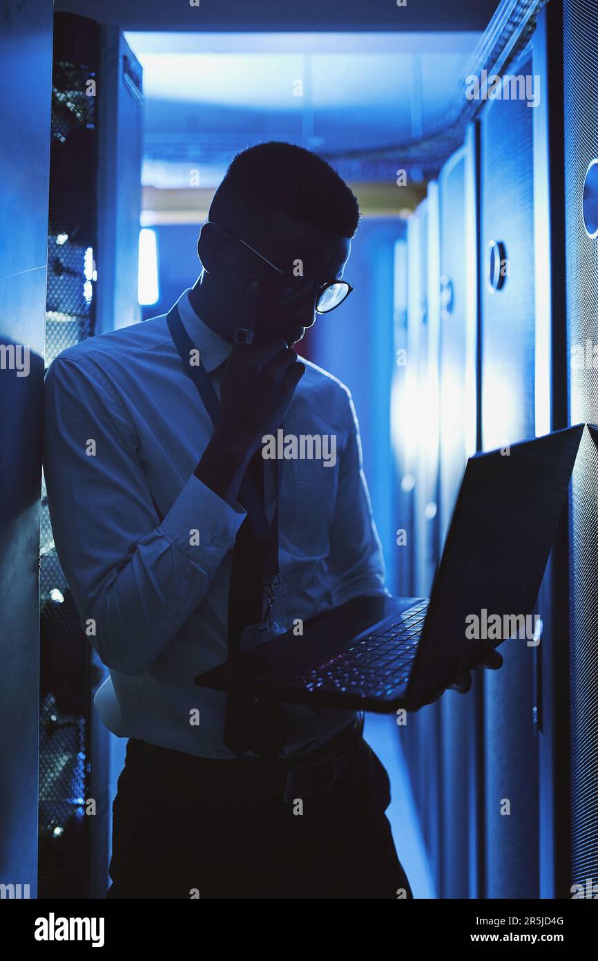 Im a problem solver. a young man working in an IT server room Stock ...