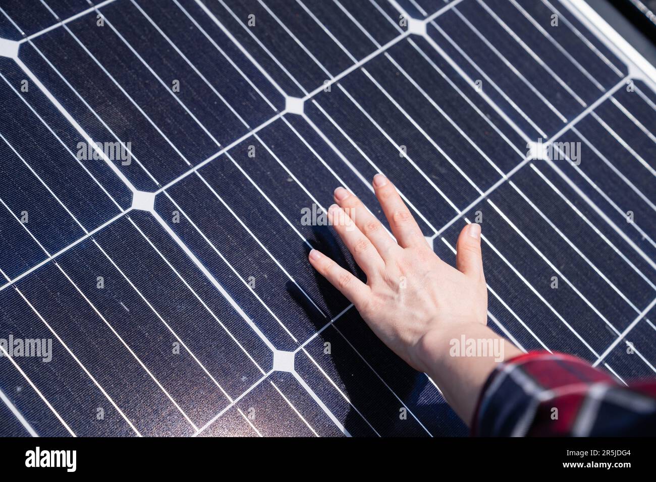 Close-up of a hand touching a solar panel Stock Photo - Alamy