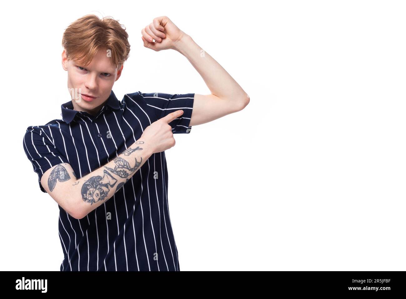 handsome 25 year old blond male with tattoos in a striped polo showing ...