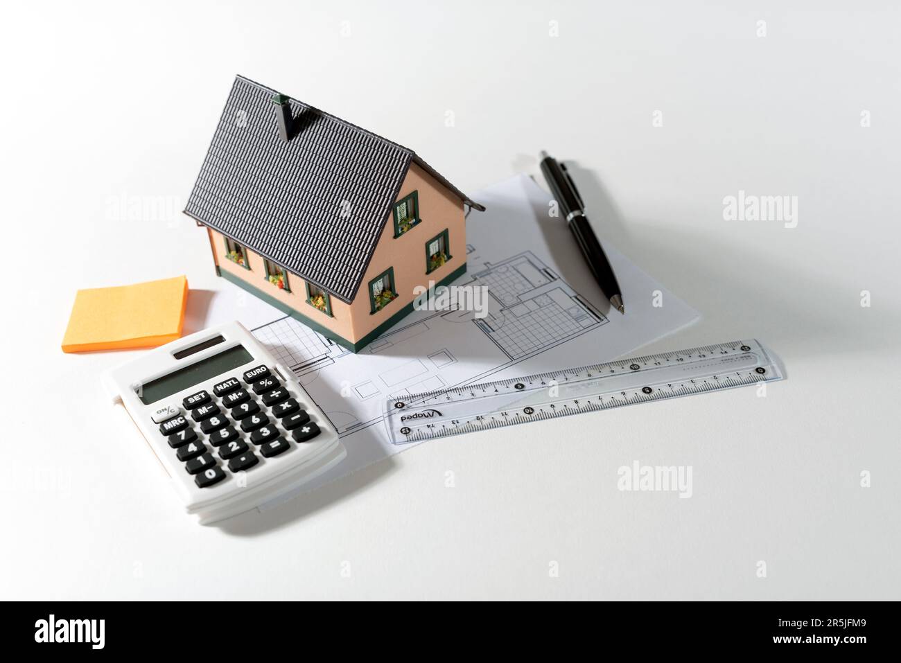 Real estate concept with house model and blueprint Stock Photo - Alamy