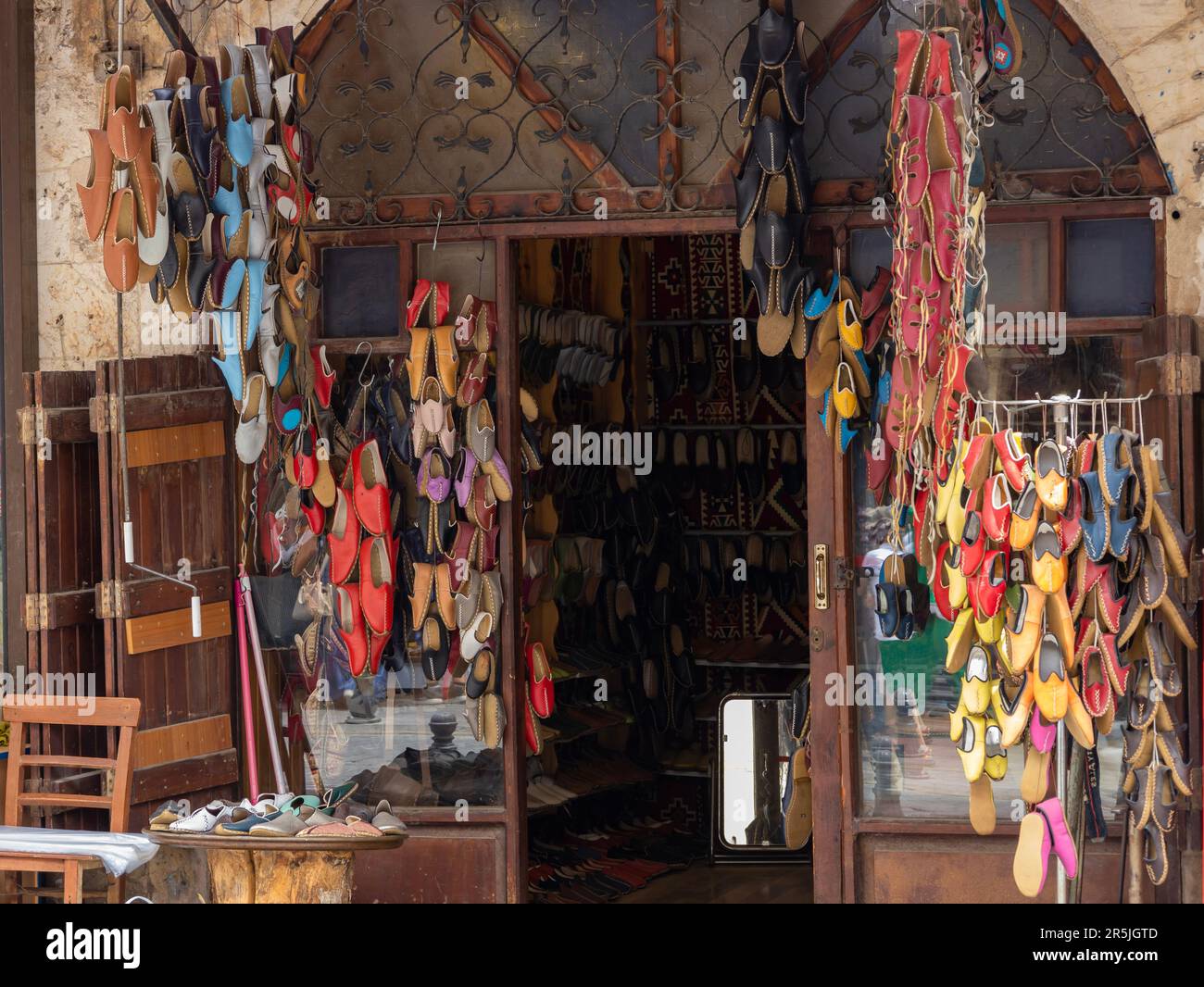 Traditional colorful Turkish handmade leather slipper shoes on a market ...
