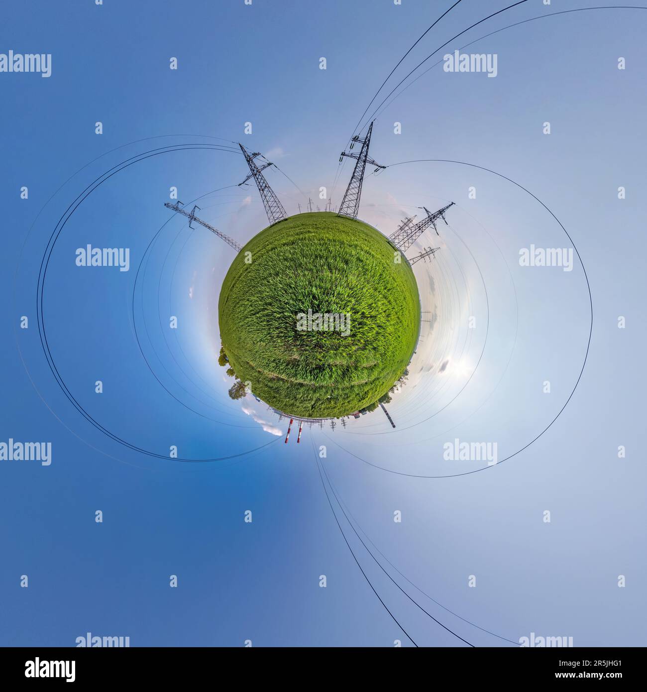 green tiny planet in blue sky with silhouette of high voltage electric ...