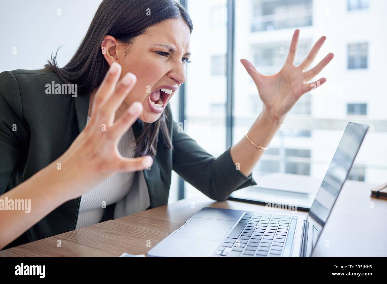 Mental health, businesswoman screaming at laptop and at her desk in her ...