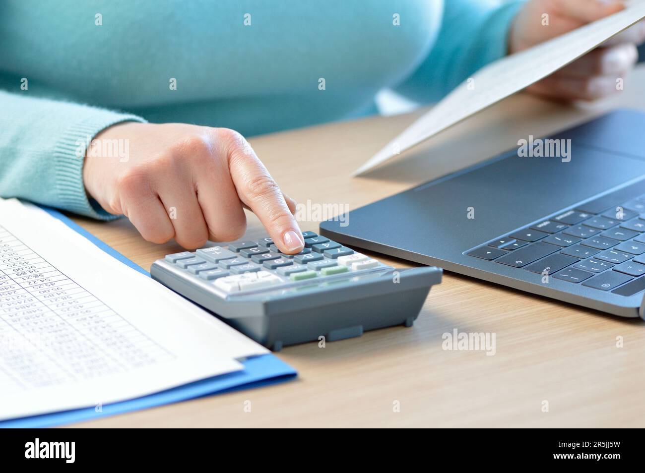 Accountant calculating with a calculator on a desk at office Stock ...