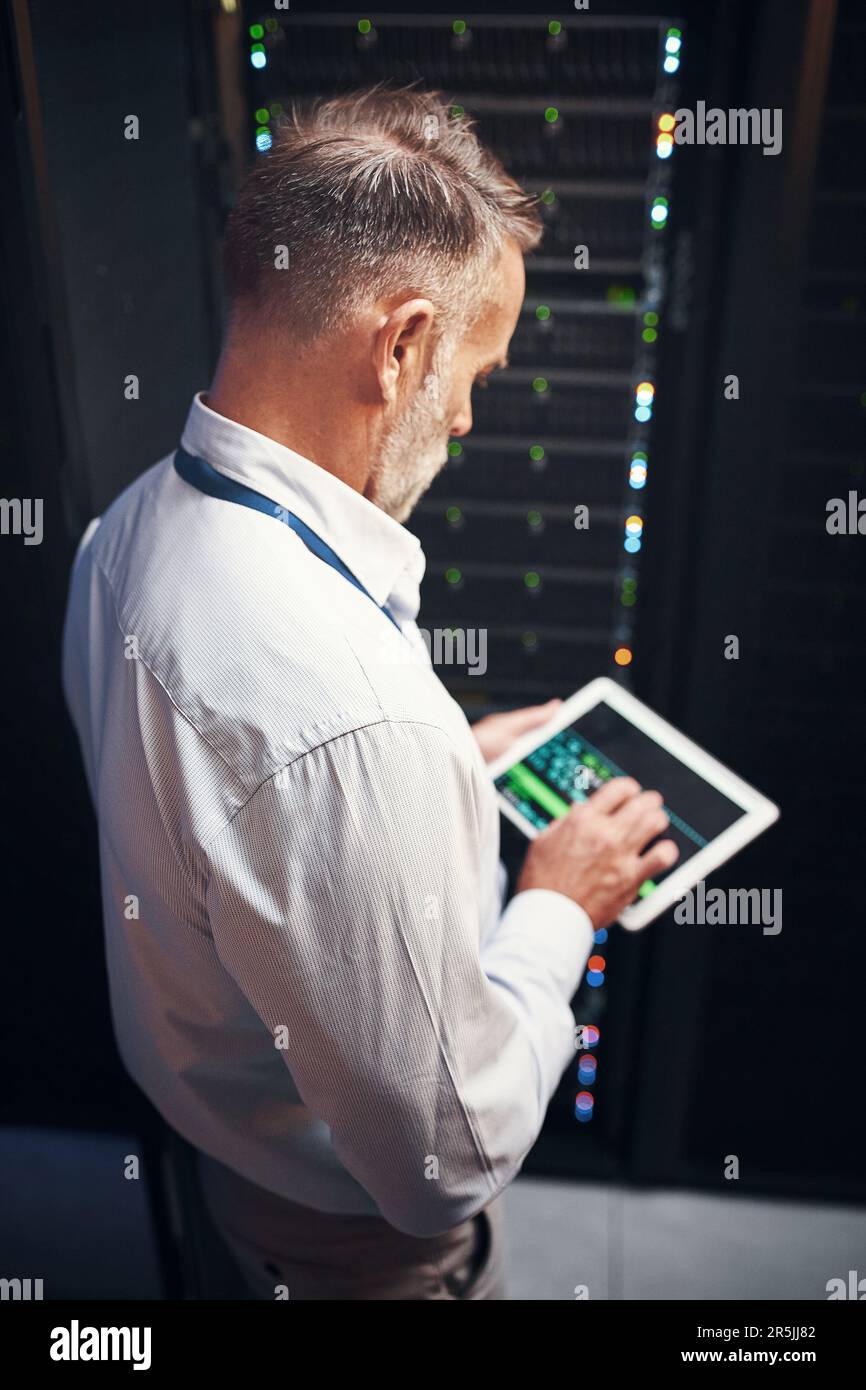 Smart technicians use smart apps. a mature man using a digital tablet ...